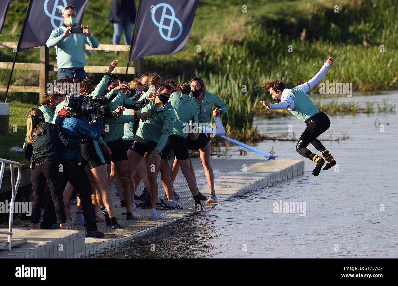 The Cambridge crew celebrates by throwing their cox into the river ...