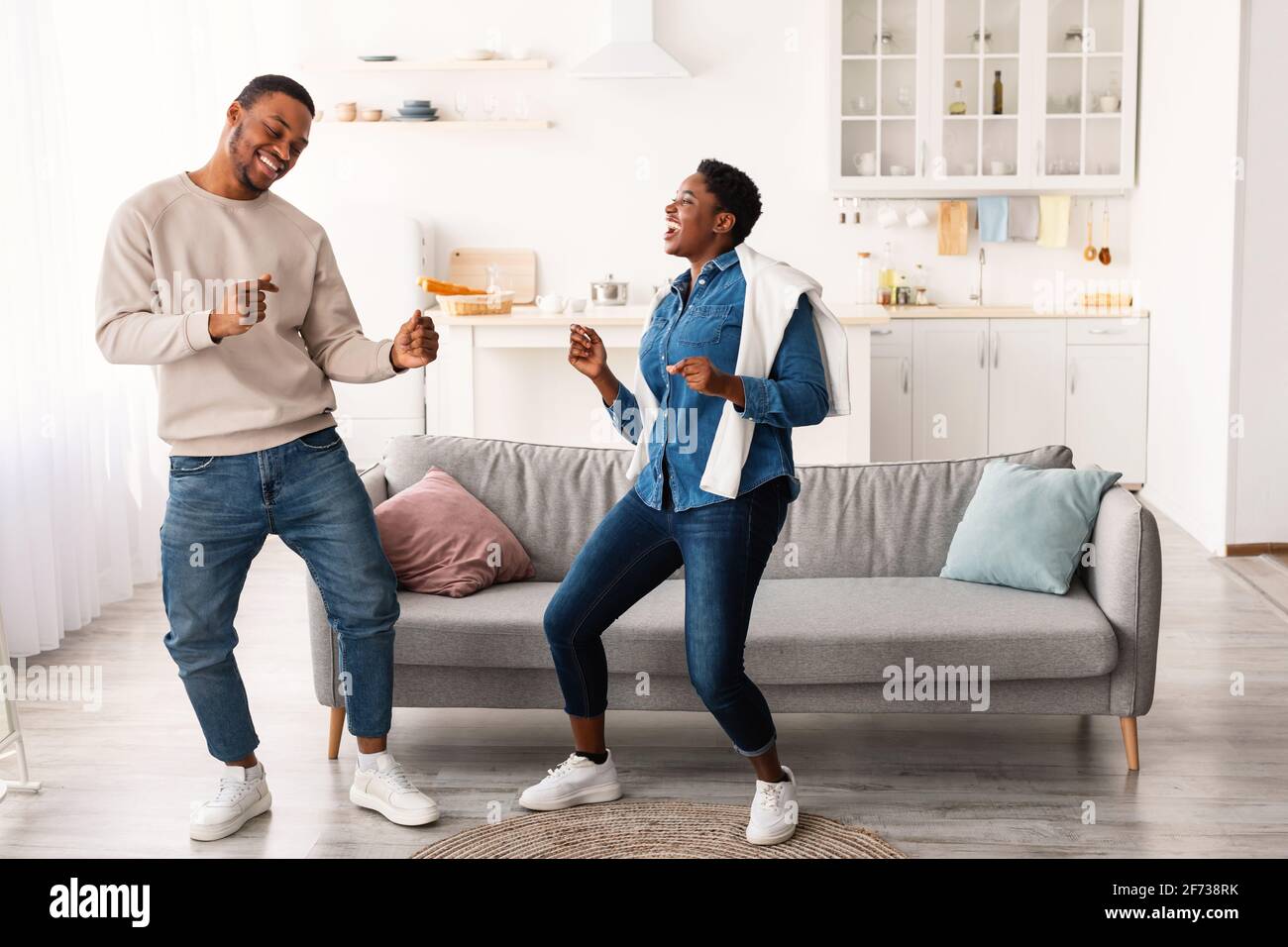 Portrait of joyful black couple dancing at home Stock Photo - Alamy