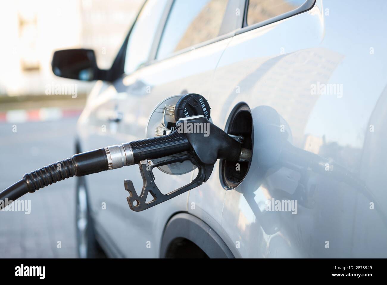 Gas pump inserted into car petrol tank, close up view, nobody. Diesel ...