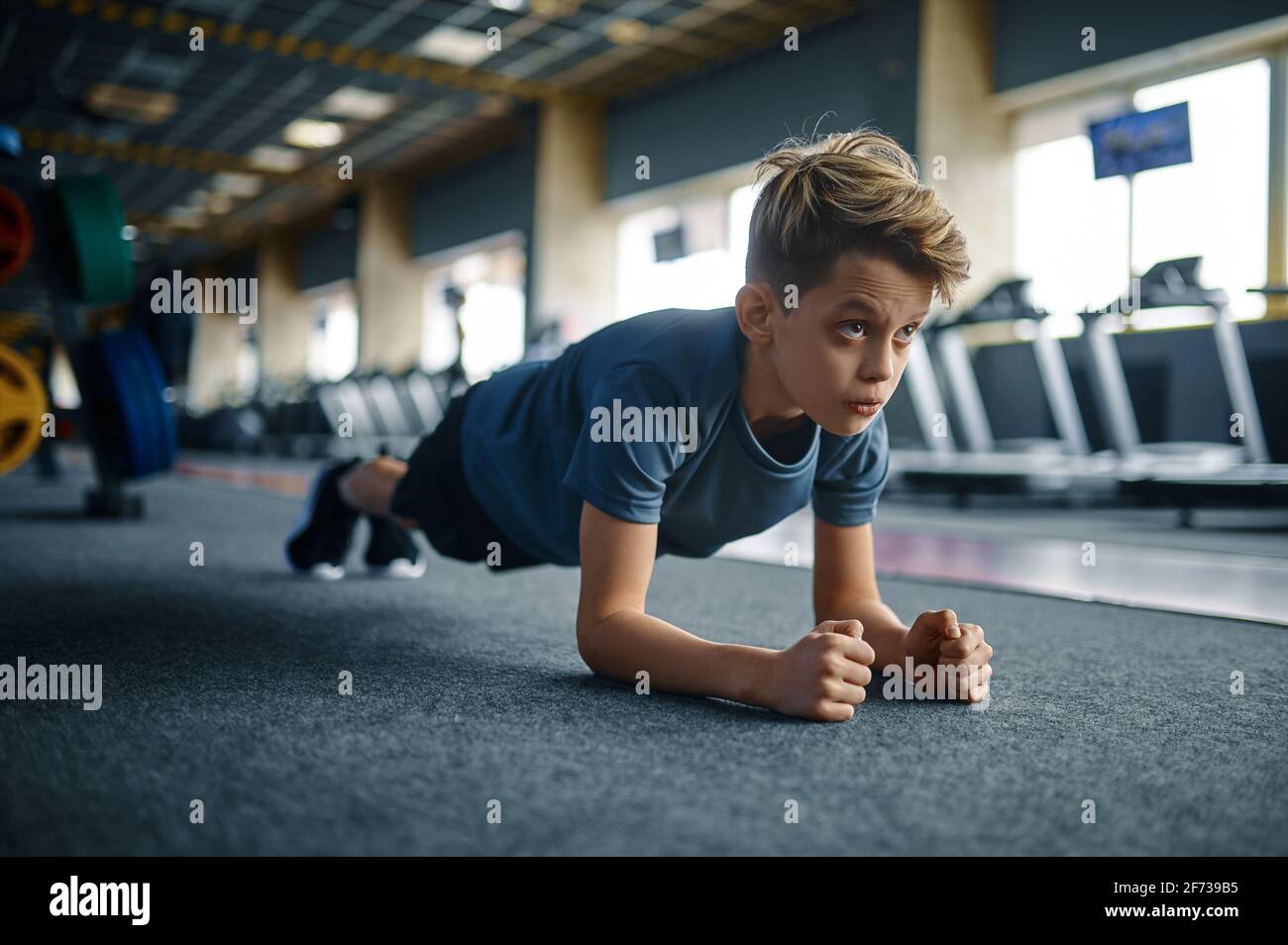 Boy doing push up exercise on the floor in gym Stock Photo - Alamy
