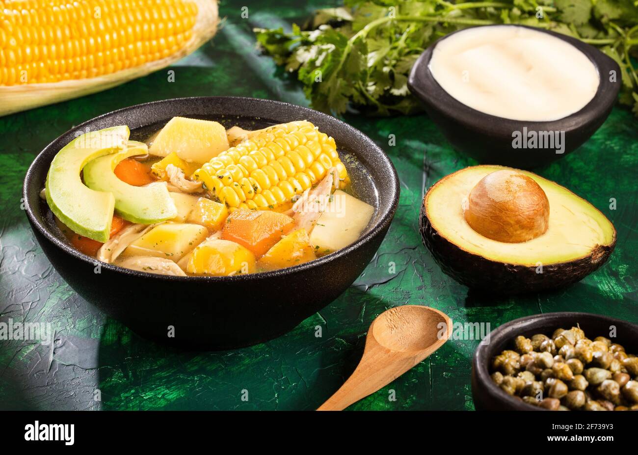 Traditional Colombian ajiaco served on black ceramic dish Stock Photo ...