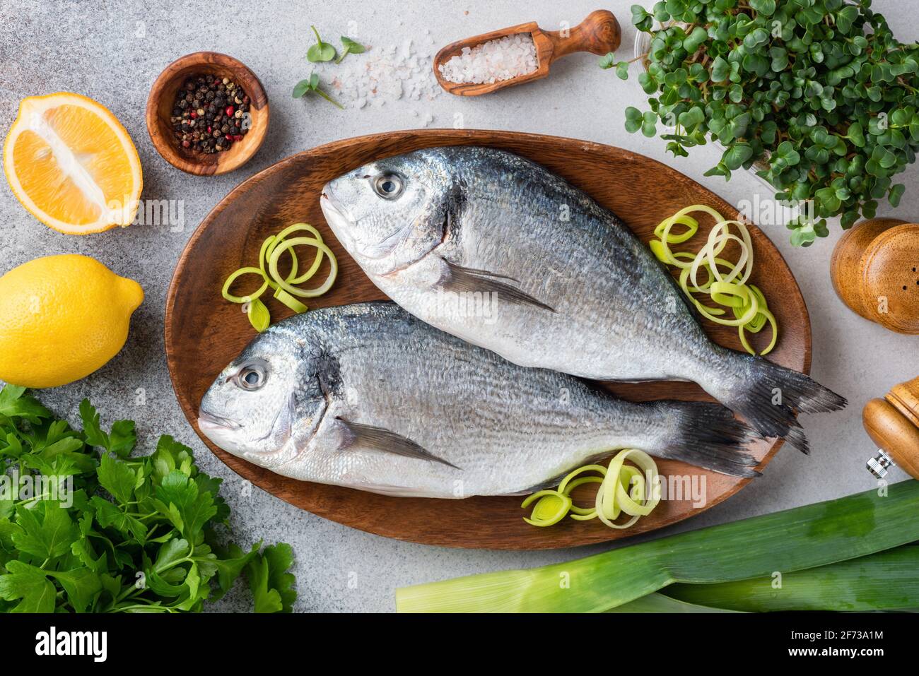 Two uncooked dorado fish and ingredients for grill fish, top view ...