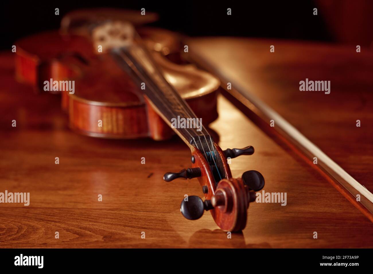 Violin in retro style on wooden table, closeup Stock Photo - Alamy