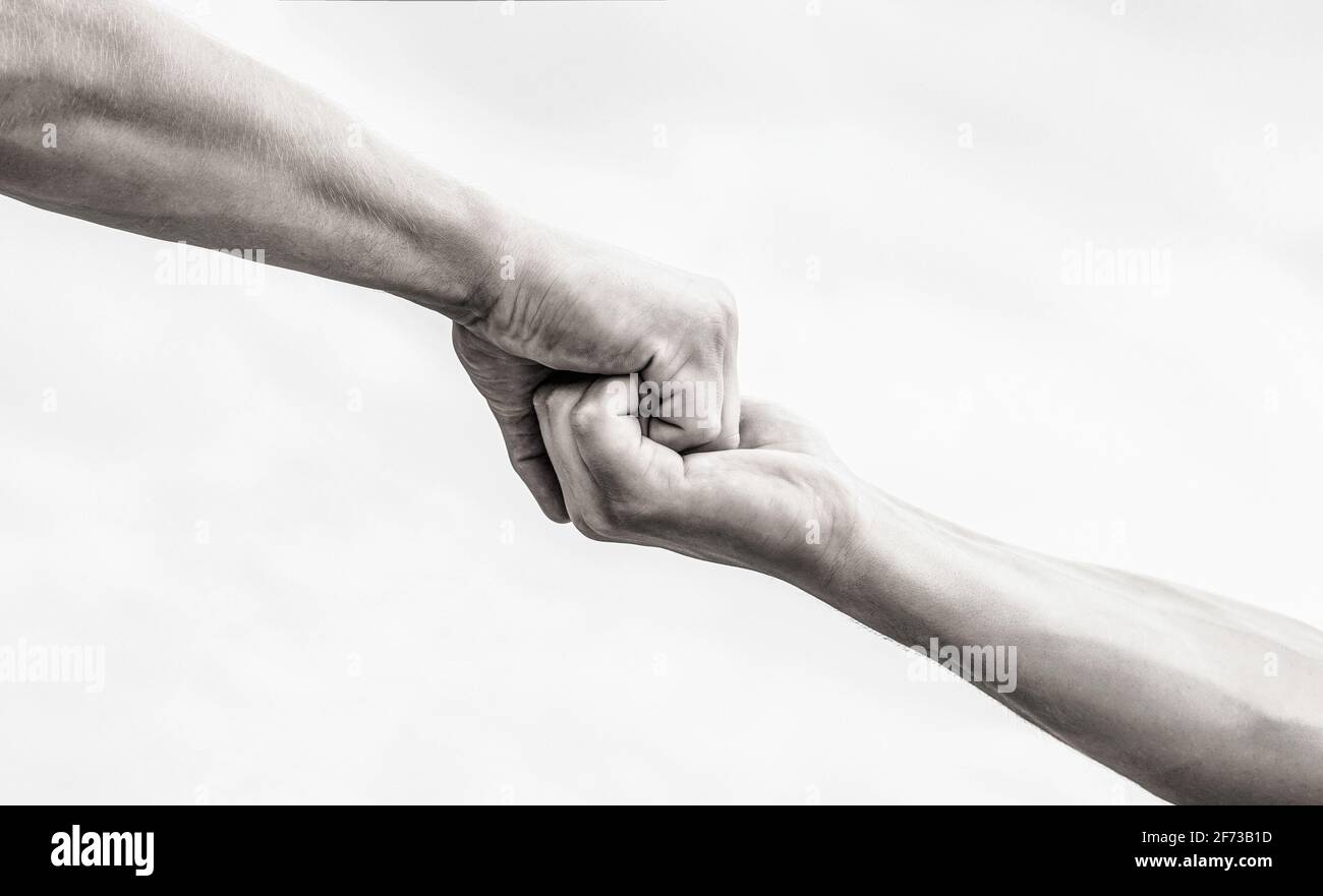 Giving a helping hand. Hands of man and woman on sky background ...