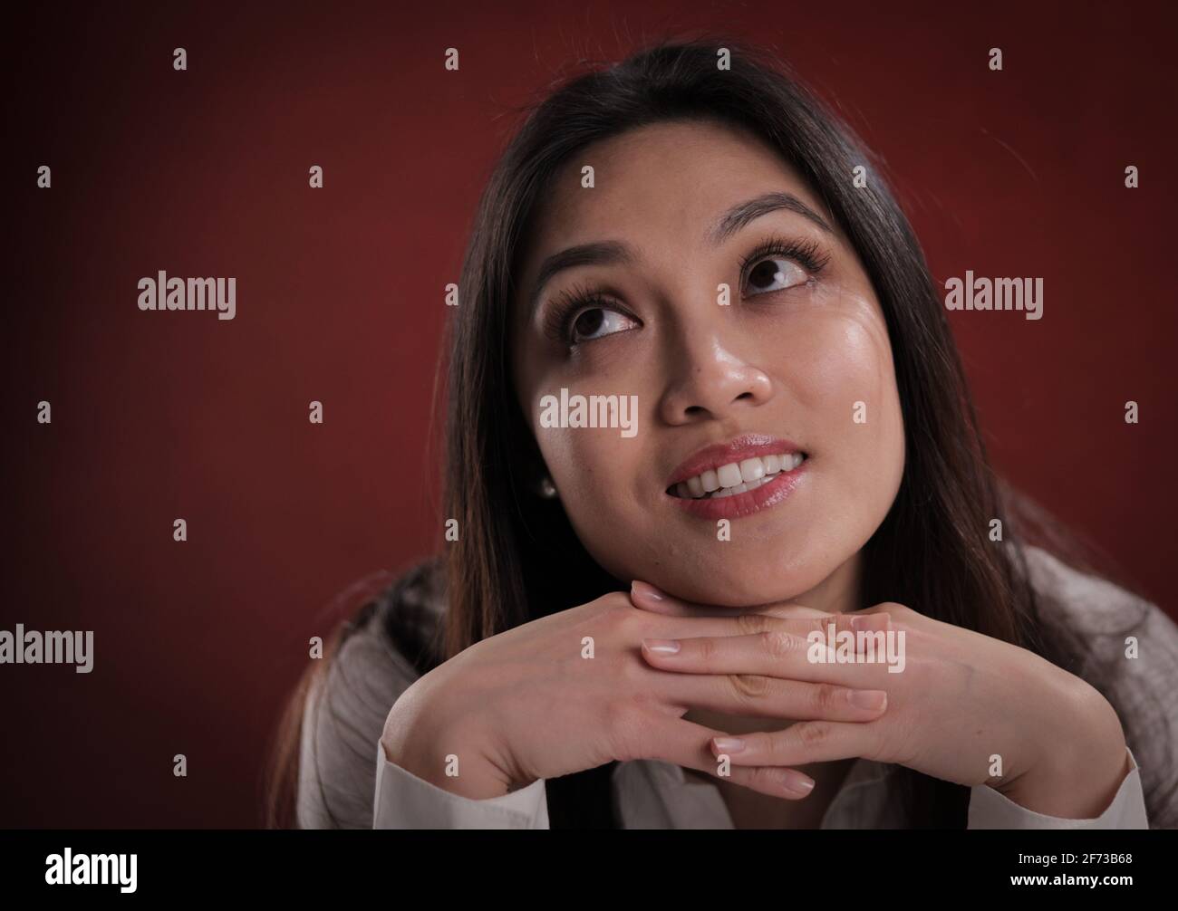 Dreamy facial expression of a young pretty woman Stock Photo - Alamy