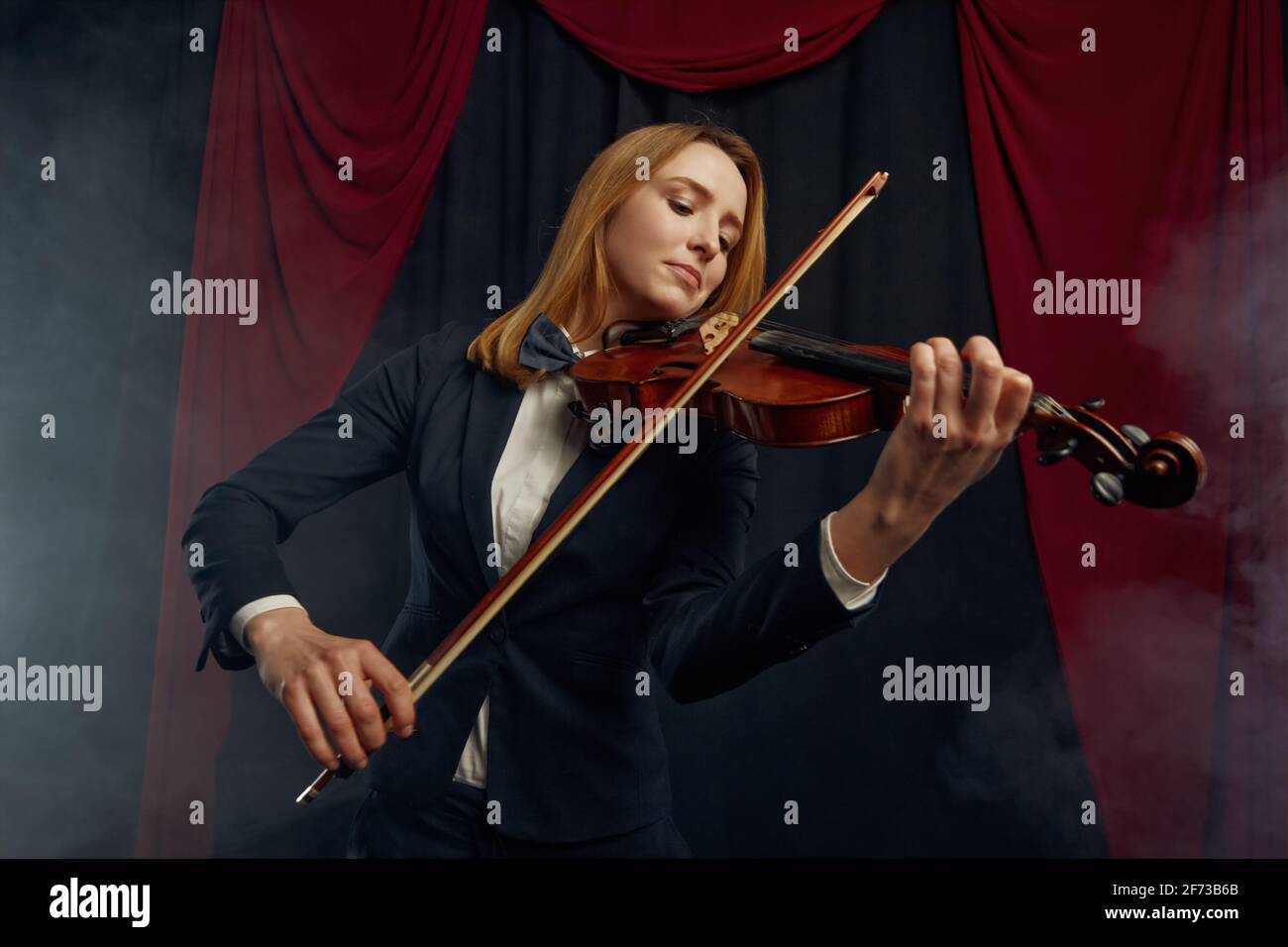 Female violonist with violin, performance on stage Stock Photo - Alamy