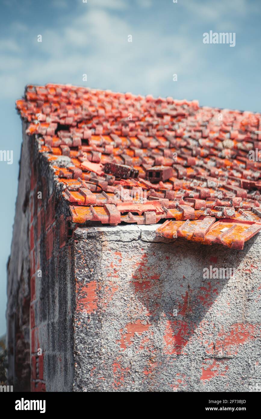 Vertical closeup view of an unfinished desolate house with a triangle ...