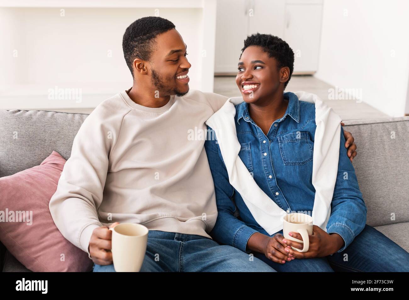 Black couple talking and spending time together sitting on couch Stock ...