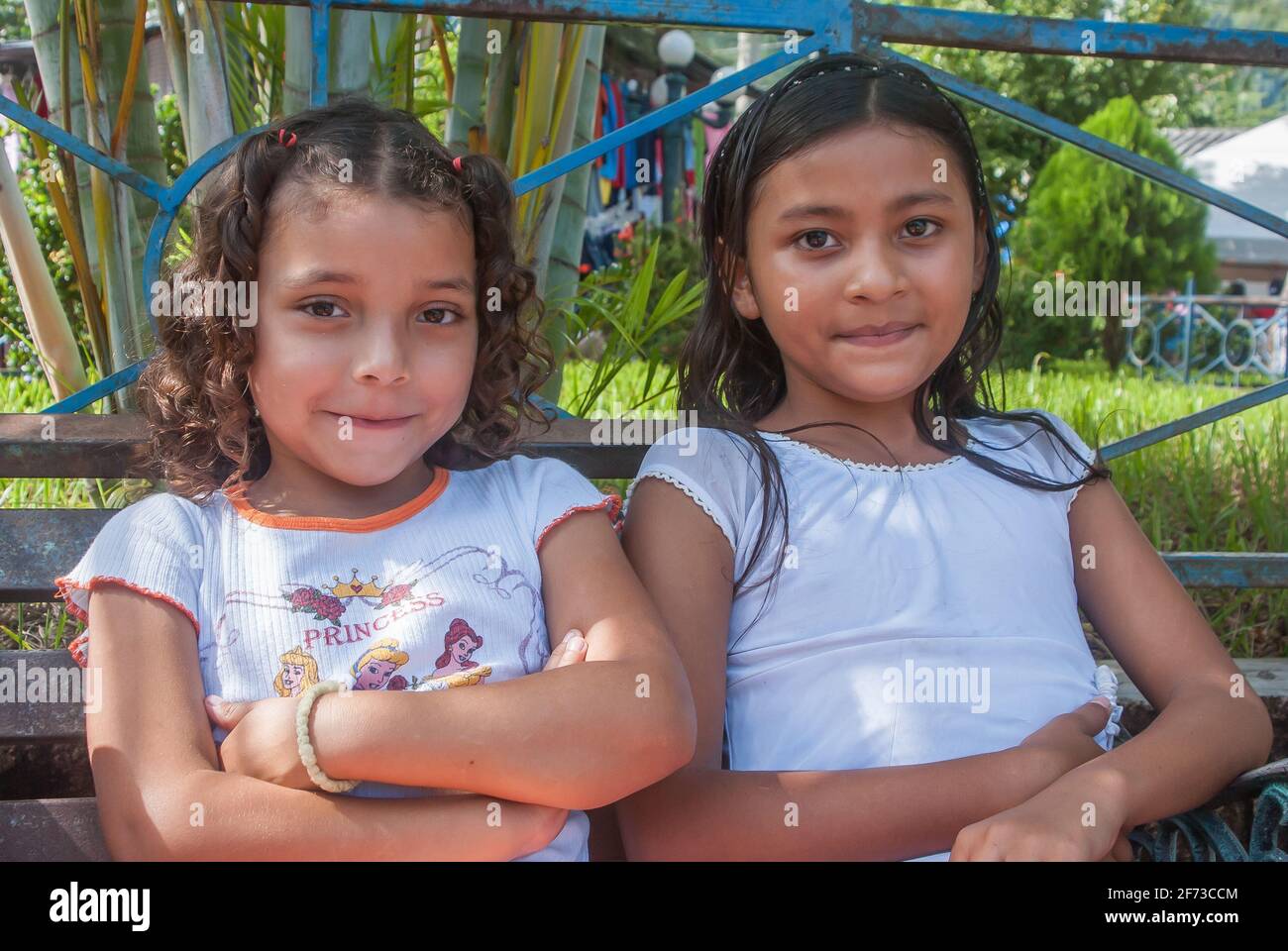 Suchitoto, El Salvador. 03-21-2019. Portrait of two girls sitting on a ...