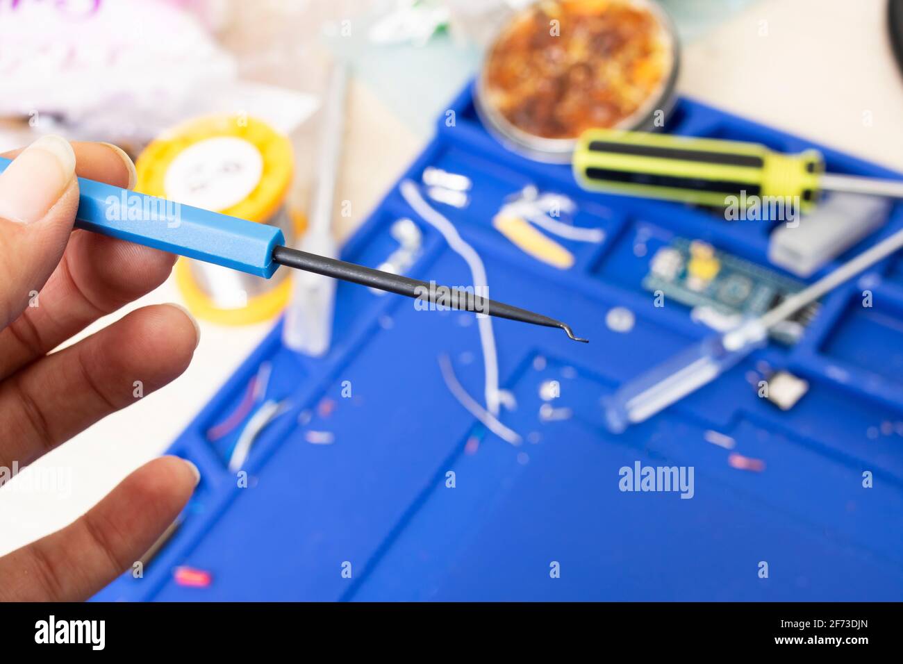 Small soldering tools in hand on desktop background close up Stock ...