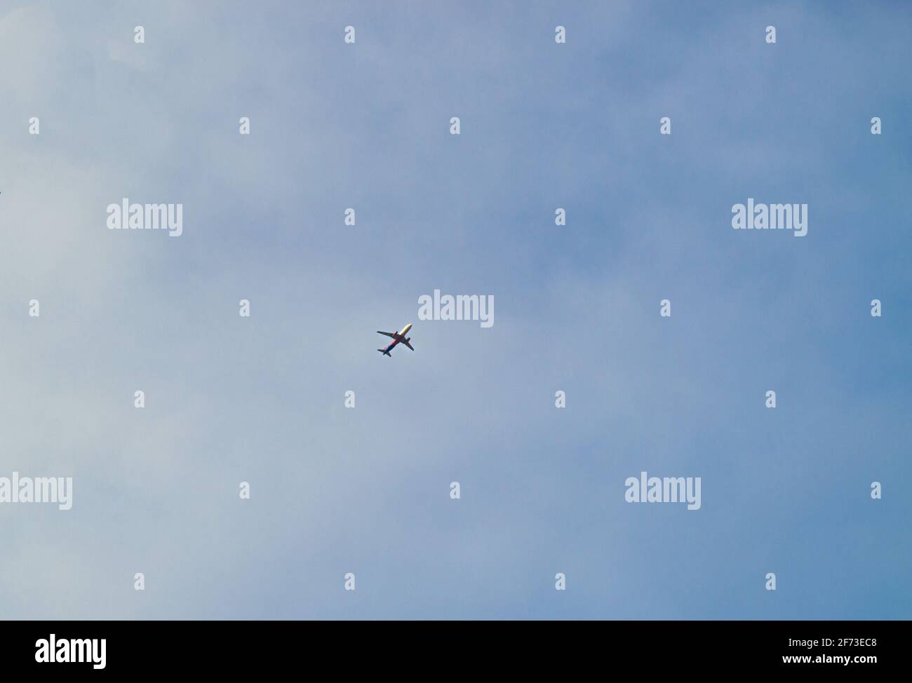Passenger plane high in the sky against the blue sky Stock Photo - Alamy
