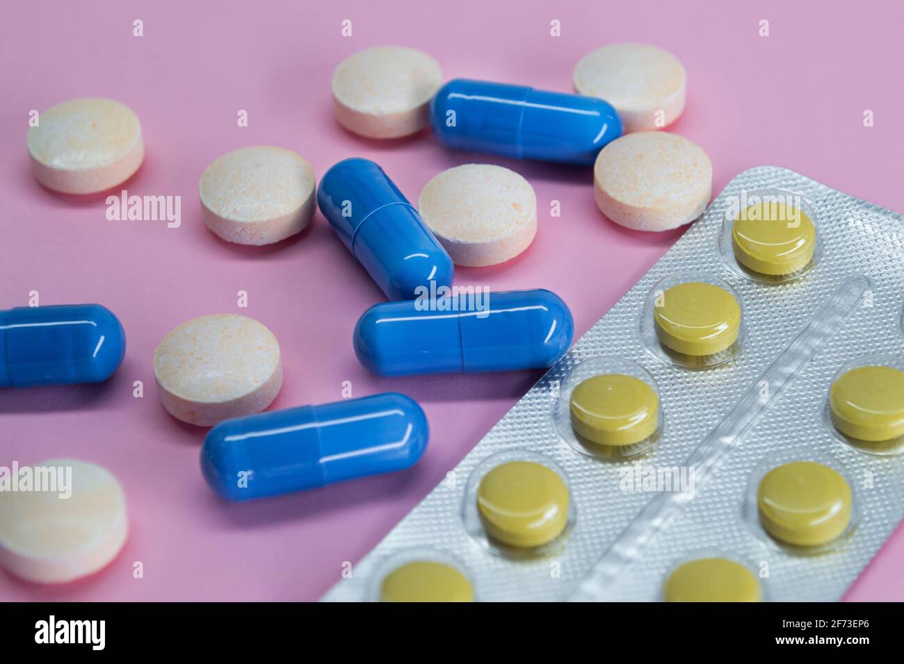 Mixed multi-colored capsules, tablets, blisters fill the entire image ...