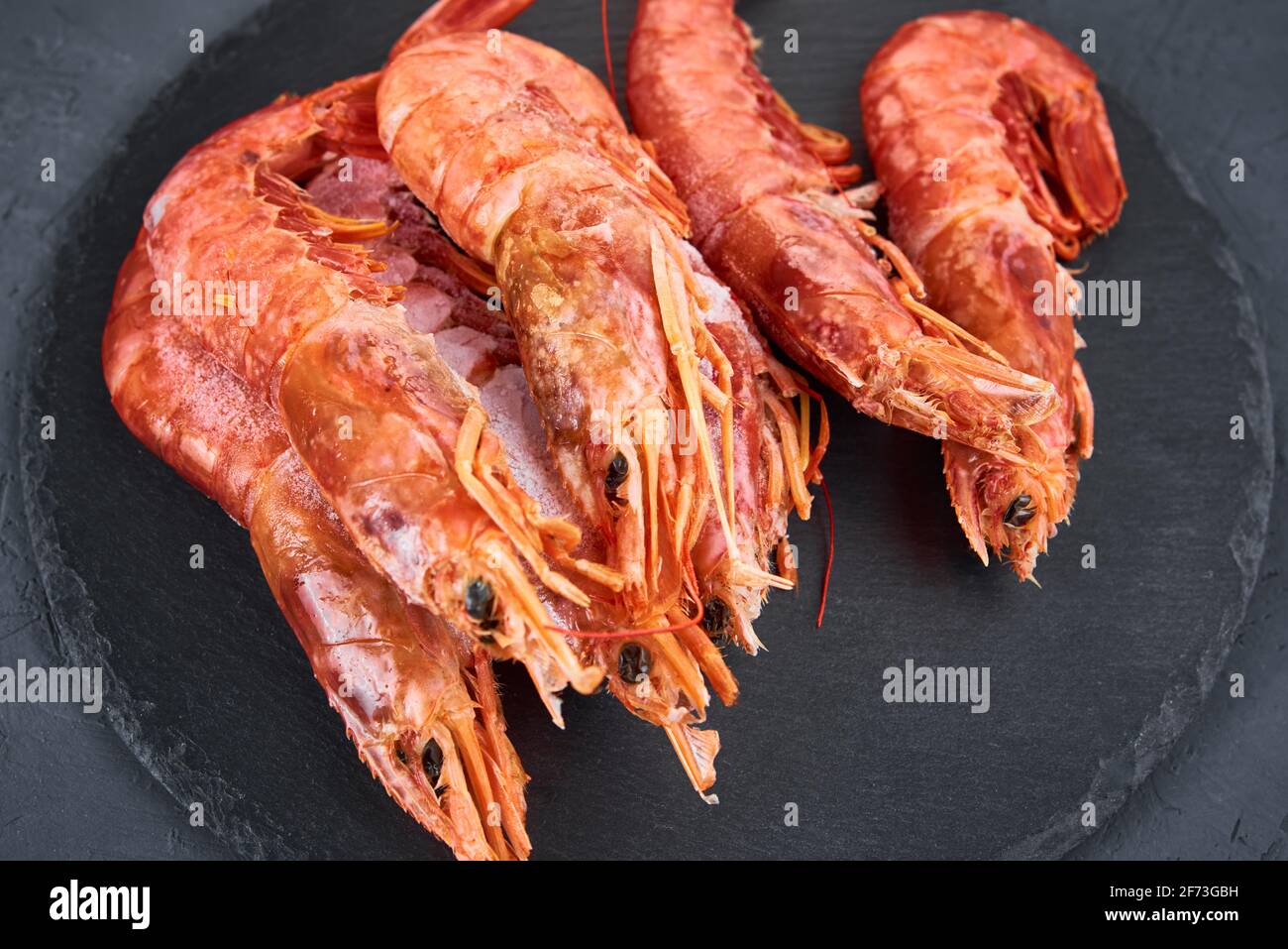 Fresh shrimps on dark background. Red raw prawns.Frozen seafood Stock ...