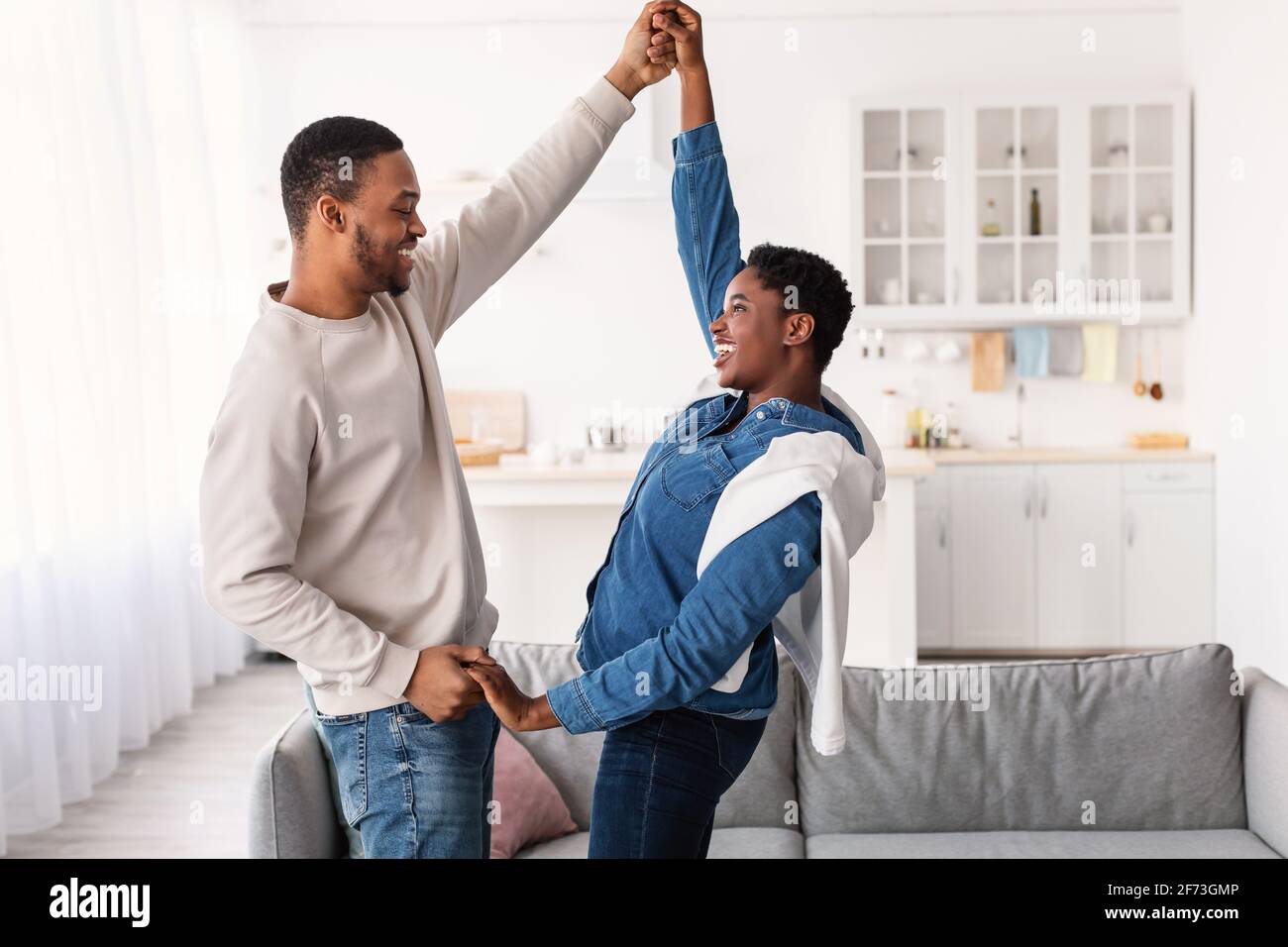 Portrait of joyful black couple dancing at home Stock Photo - Alamy