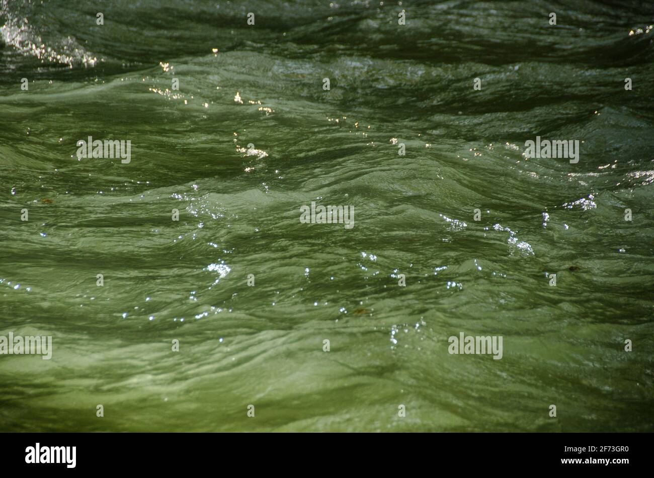 Abstract background of river water flow under the influence of light ...