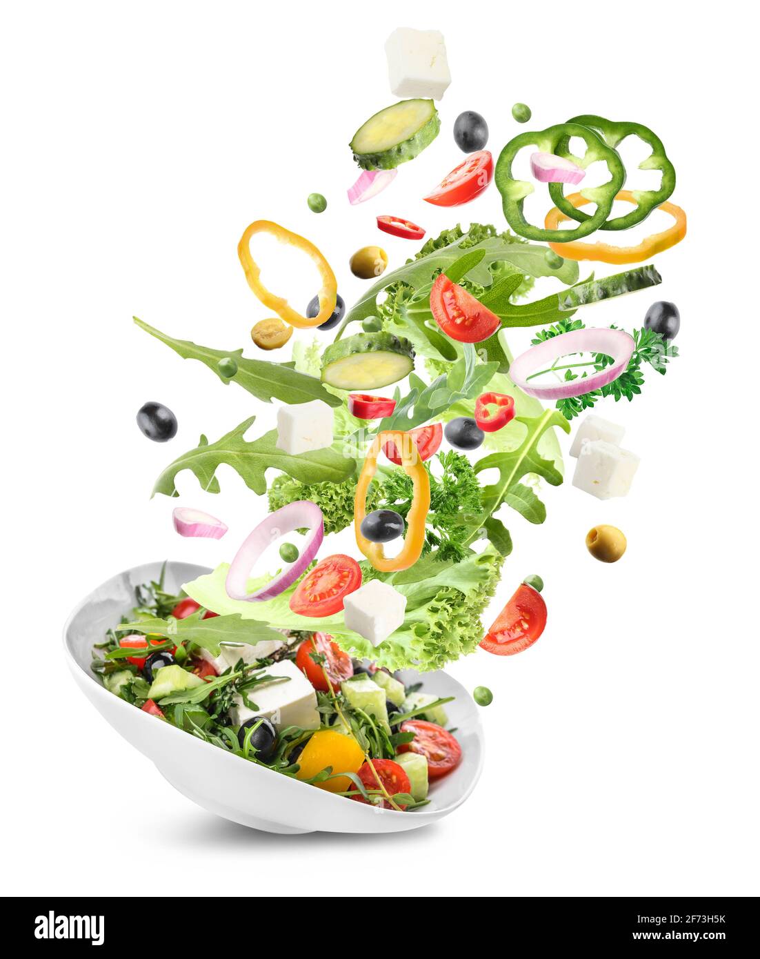 Bowl with healthy salad and flying ingredients on white background ...