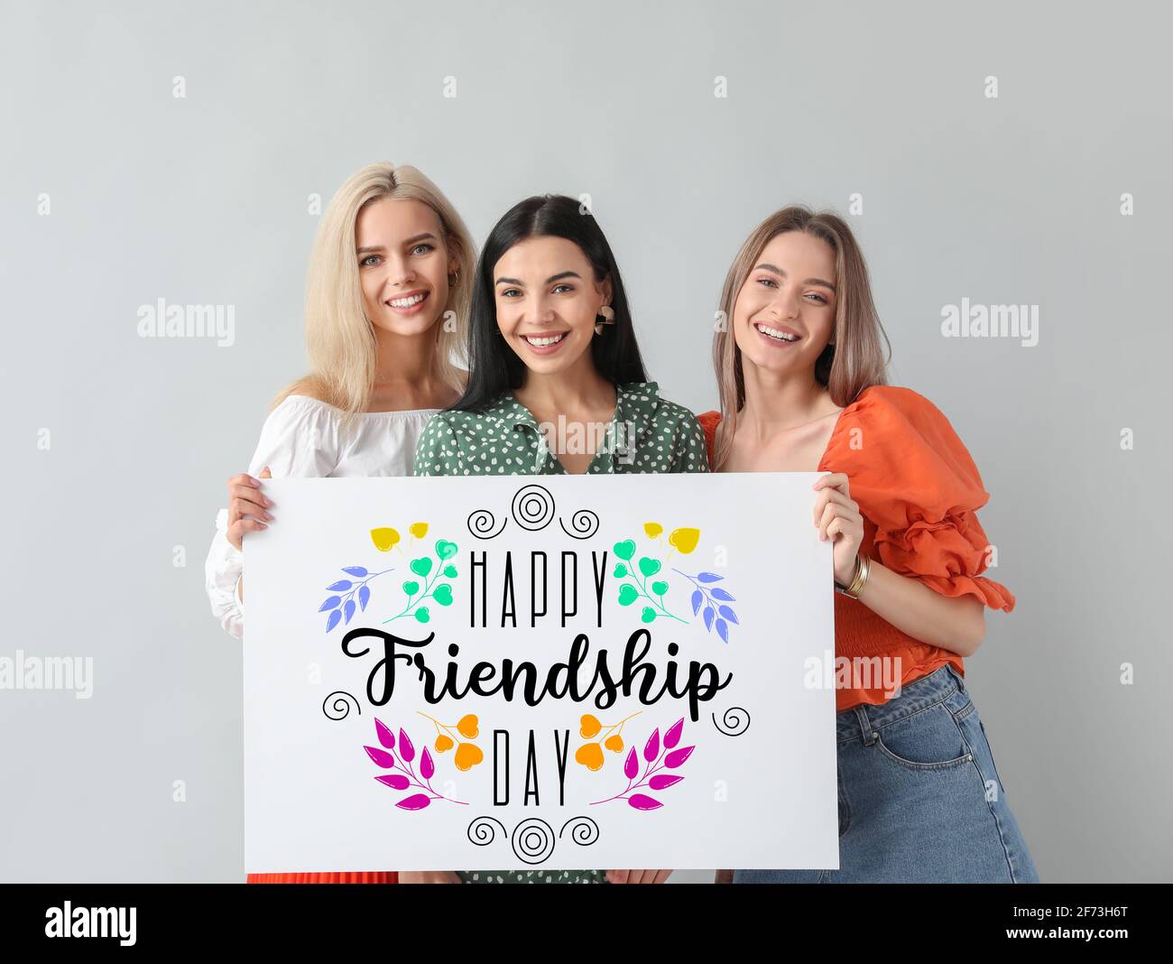 Beautiful young women with poster for Friendship Day celebration on ...