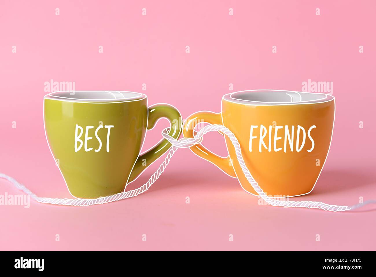 Cups tied together with rope on color background. Friendship Day ...
