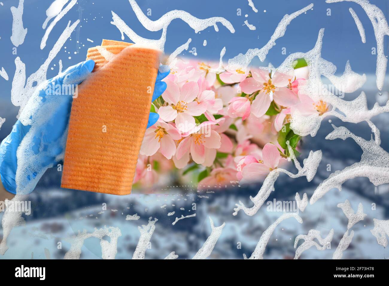 Janitor washing window with detergent. Spring cleaning Stock Photo - Alamy