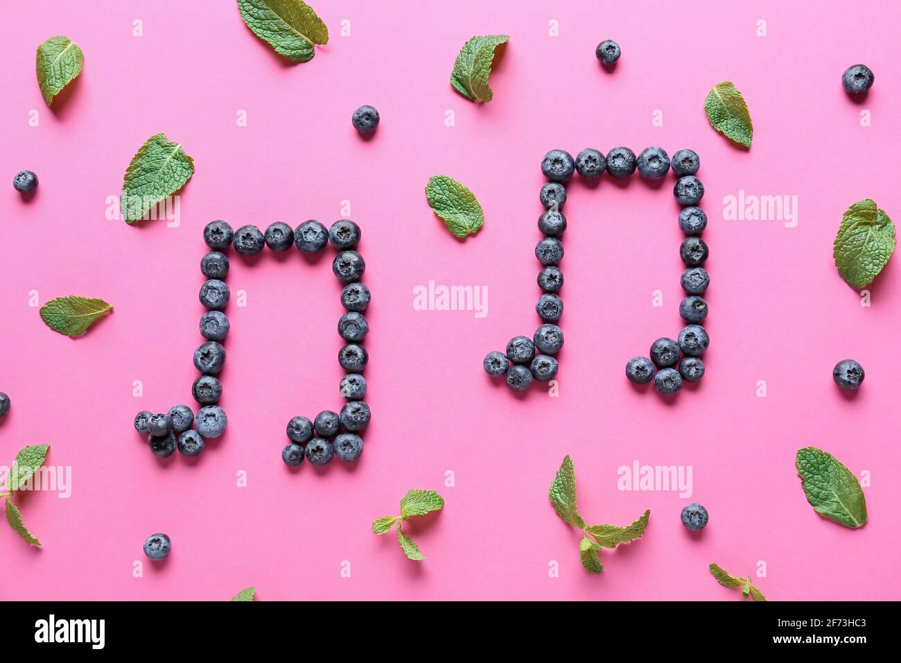 Music notes made of blueberries on color background Stock Photo - Alamy
