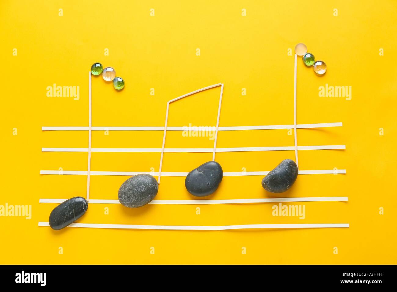 Music notes made of stones on color background Stock Photo - Alamy