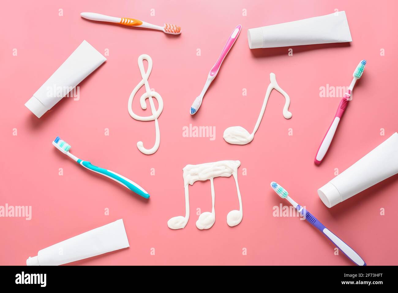 Drawn music notes and tooth brushes with paste on color background ...