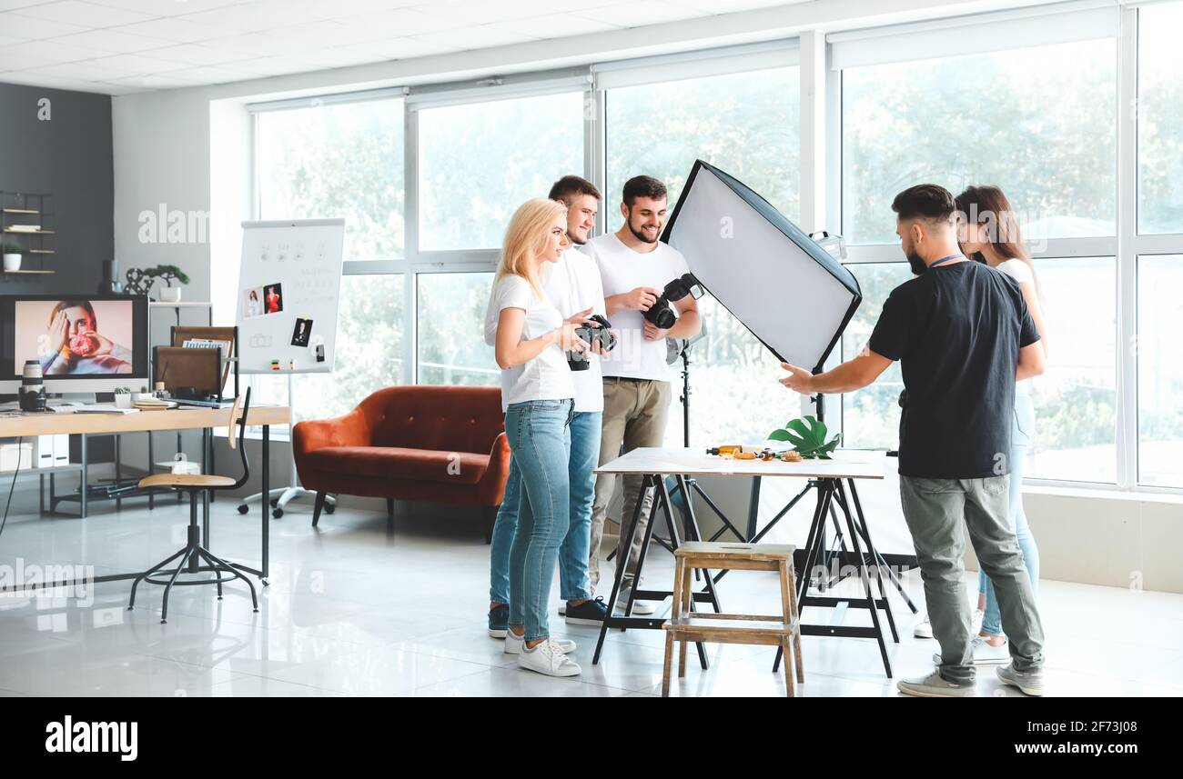 Mentor teaching young photographers in studio Stock Photo - Alamy