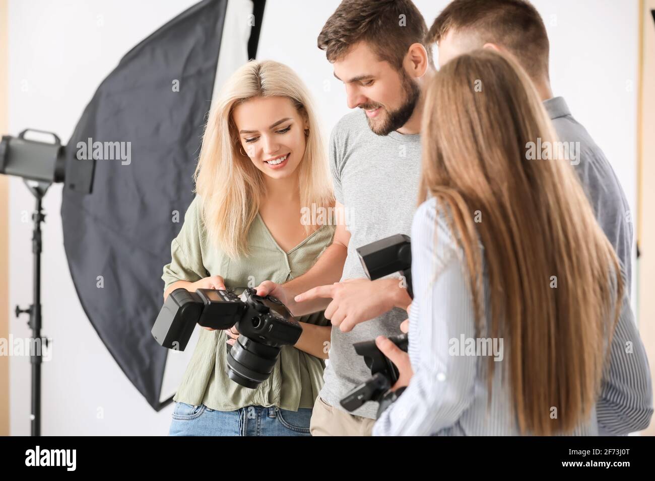 Group of young photographers in studio Stock Photo - Alamy