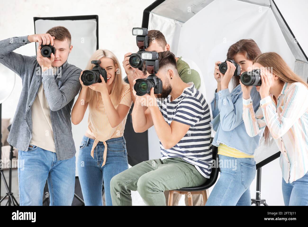 Group of young photographers in studio Stock Photo - Alamy