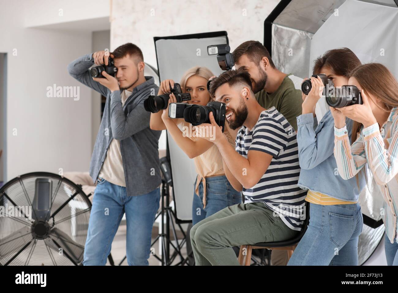 Group of young photographers in studio Stock Photo - Alamy