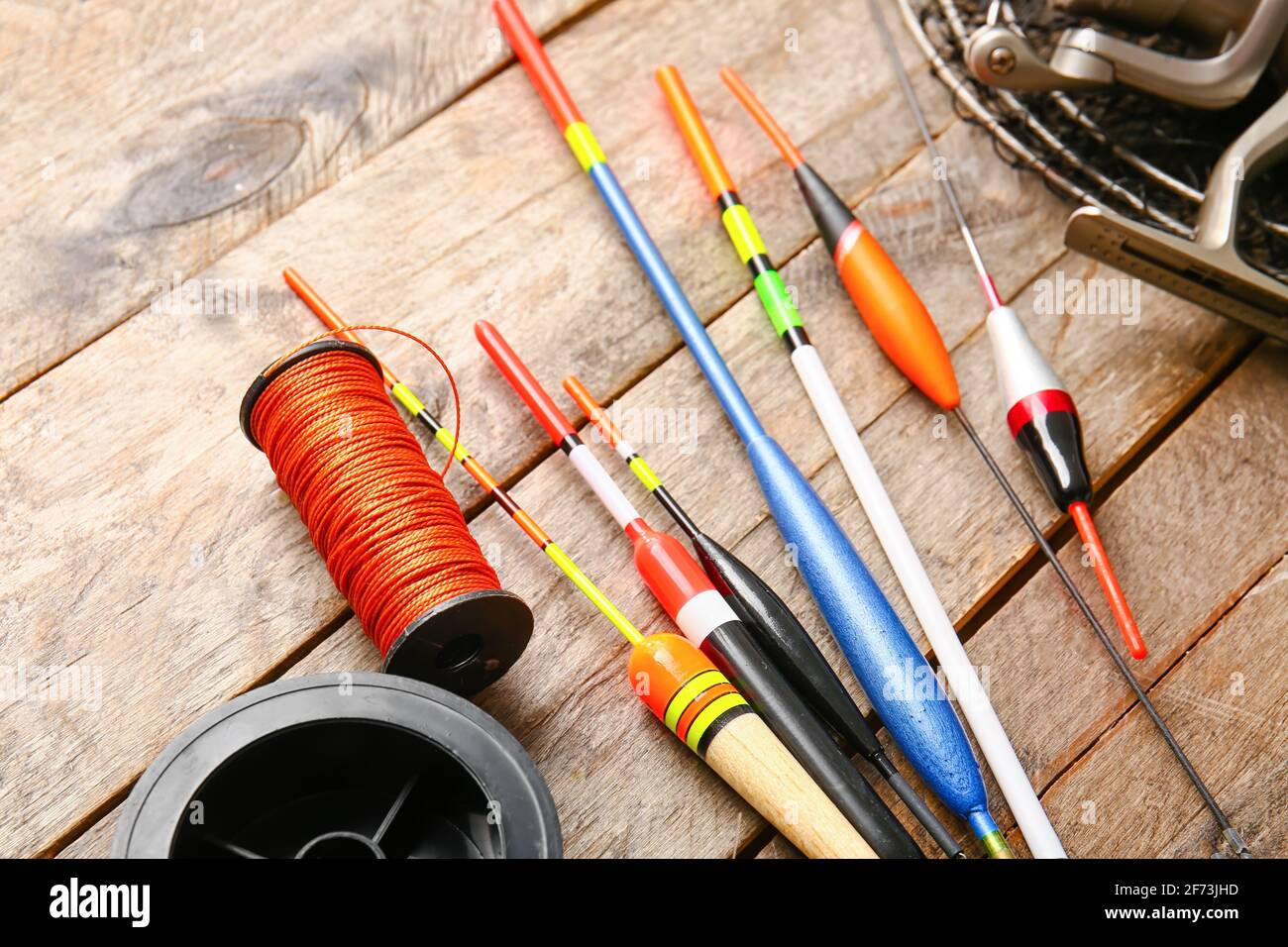 Different fishing equipment on wooden background Stock Photo - Alamy