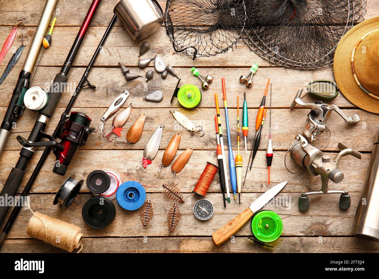 Different fishing equipment on wooden background Stock Photo - Alamy