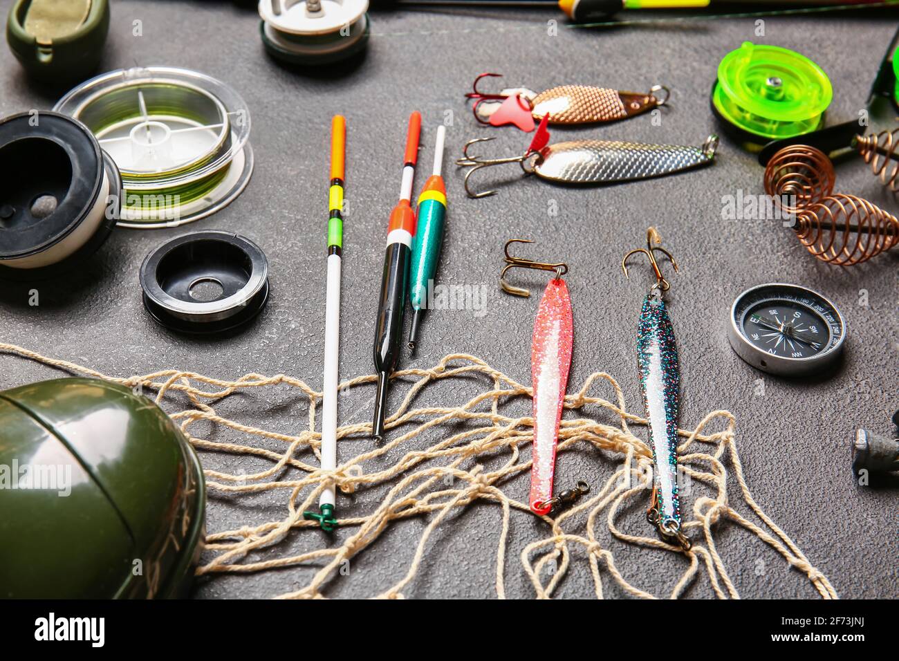 Different fishing equipment on dark background Stock Photo - Alamy