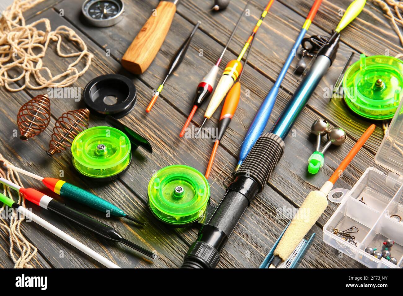 Different fishing equipment on wooden background Stock Photo - Alamy