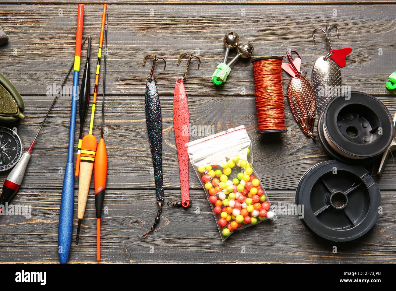 Different fishing equipment on wooden background Stock Photo - Alamy