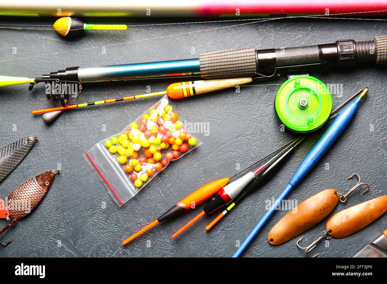Different fishing equipment on dark background Stock Photo - Alamy