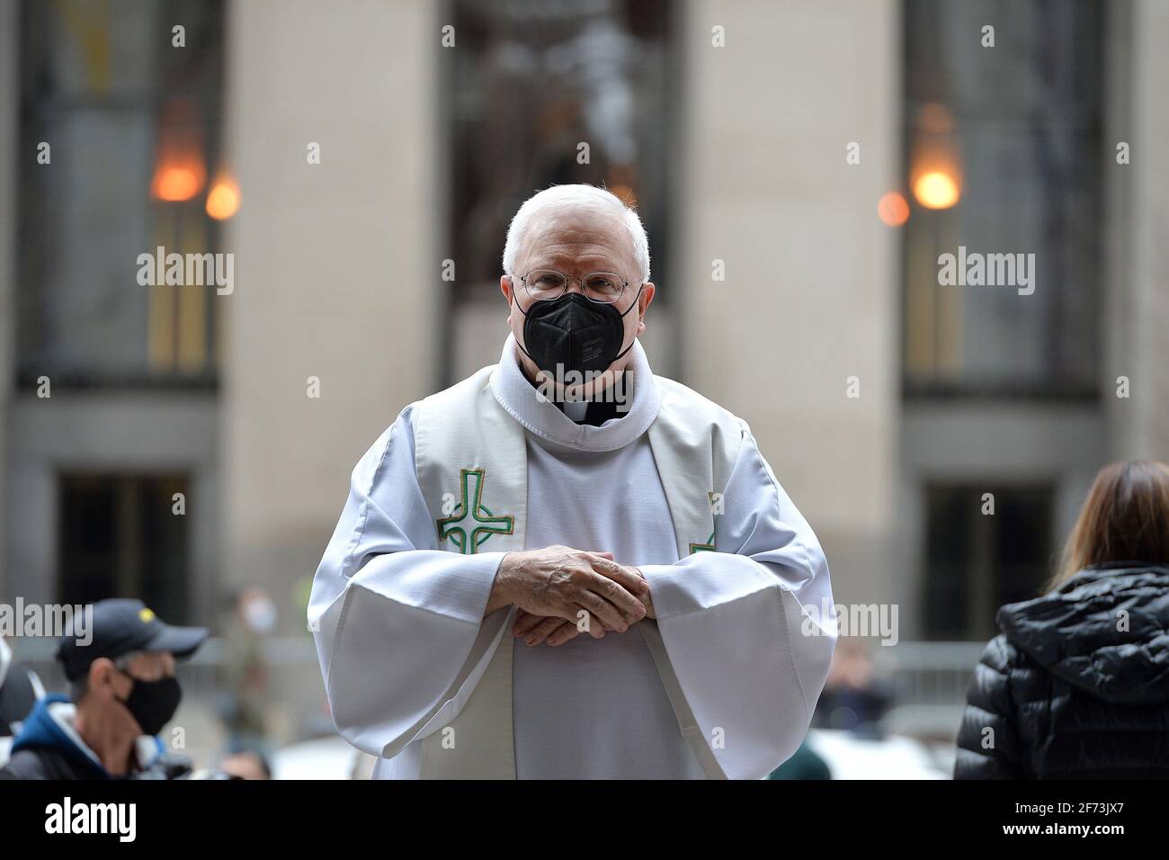 Father Docherty greets churchgoers after attending Sunday Easter Mass ...