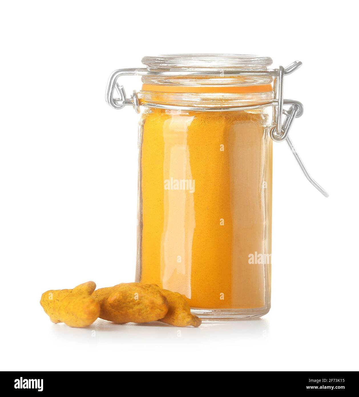 Jar with turmeric powder and root on white background Stock Photo - Alamy