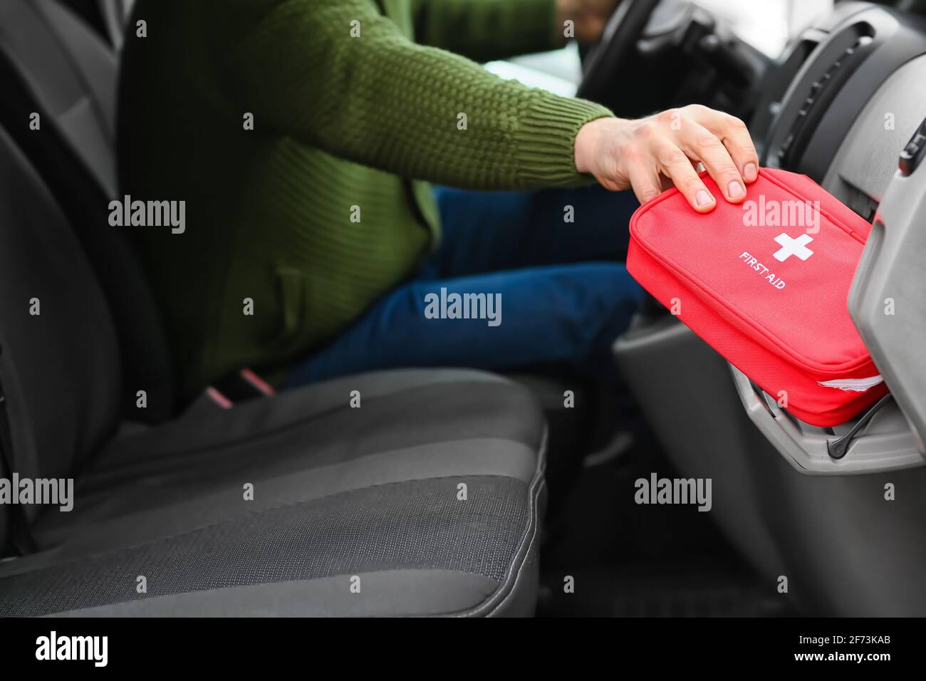 Man taking first aid kit from car's glove compartment Stock Photo - Alamy