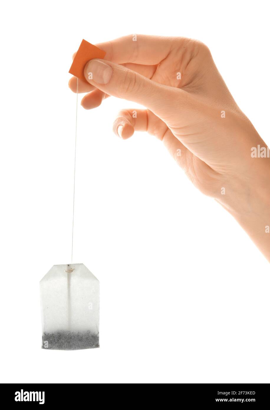 Woman holding tea bag on white background Stock Photo - Alamy