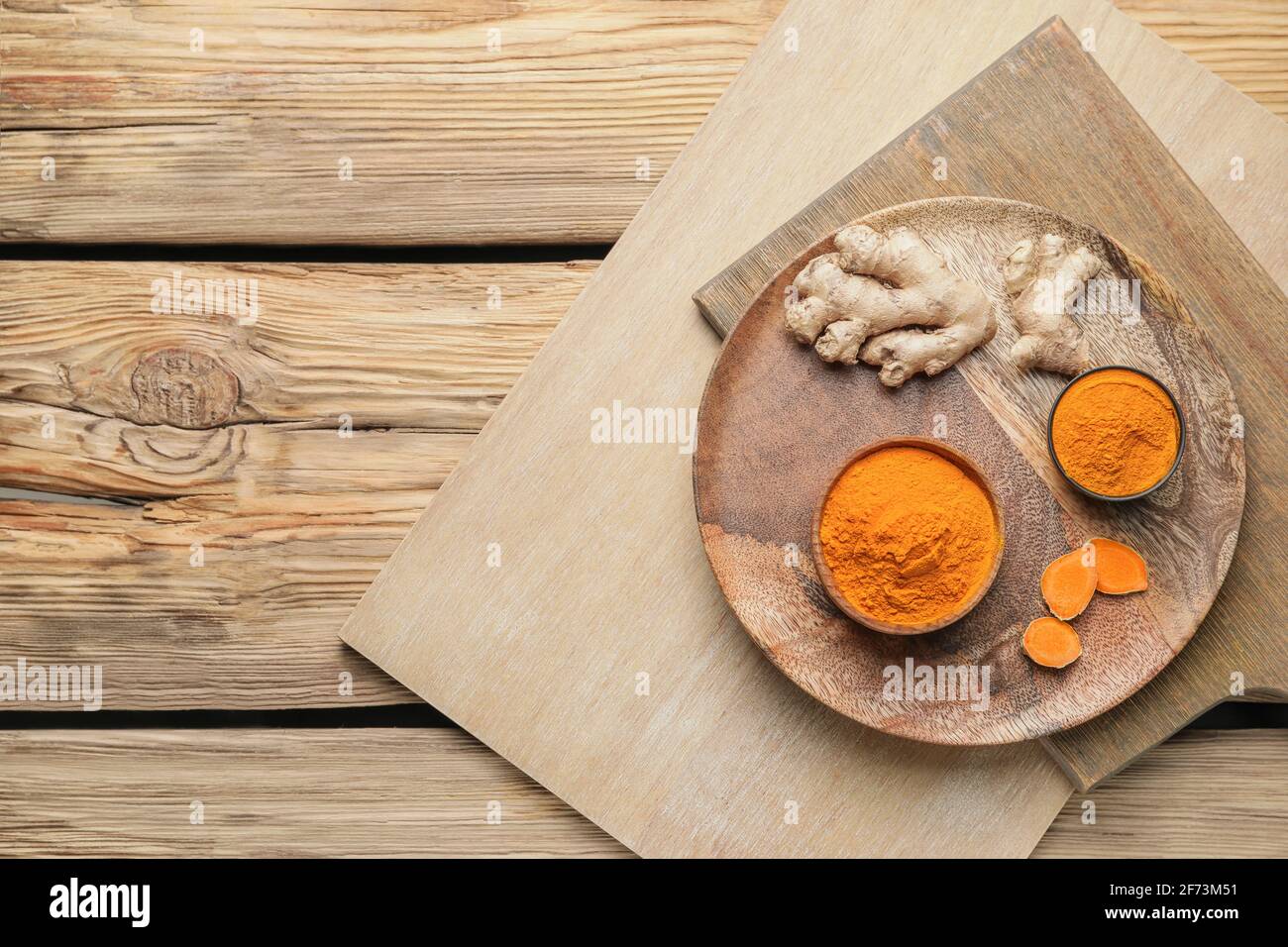 Composition with turmeric powder on wooden background Stock Photo - Alamy