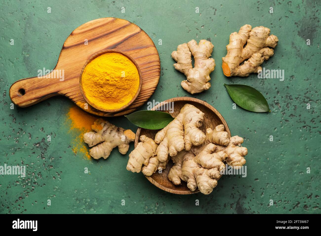 Composition with turmeric powder and roots on color background Stock ...