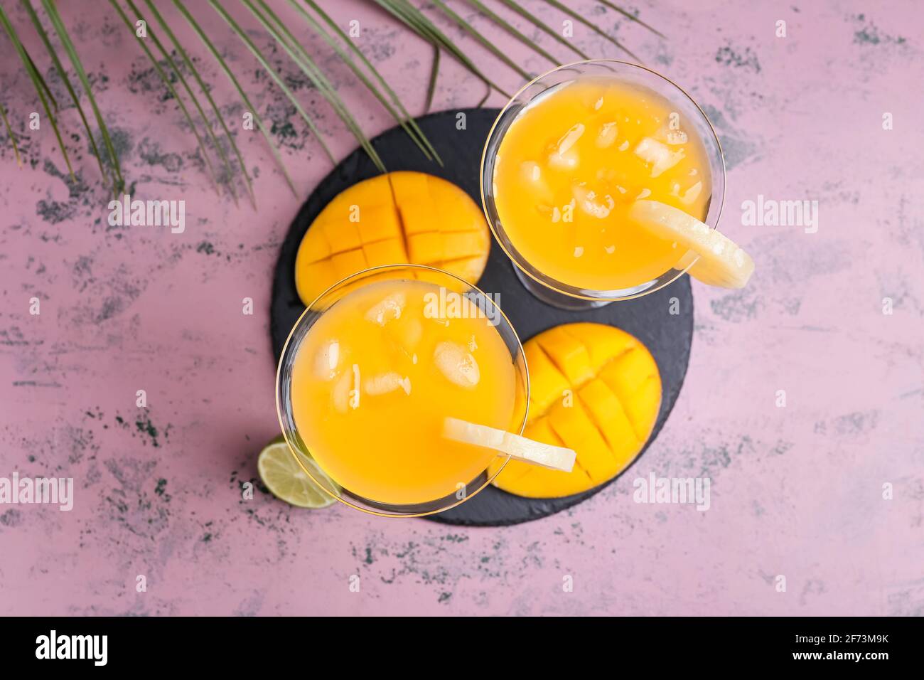 Glasses of tasty mango margarita on grunge background Stock Photo - Alamy