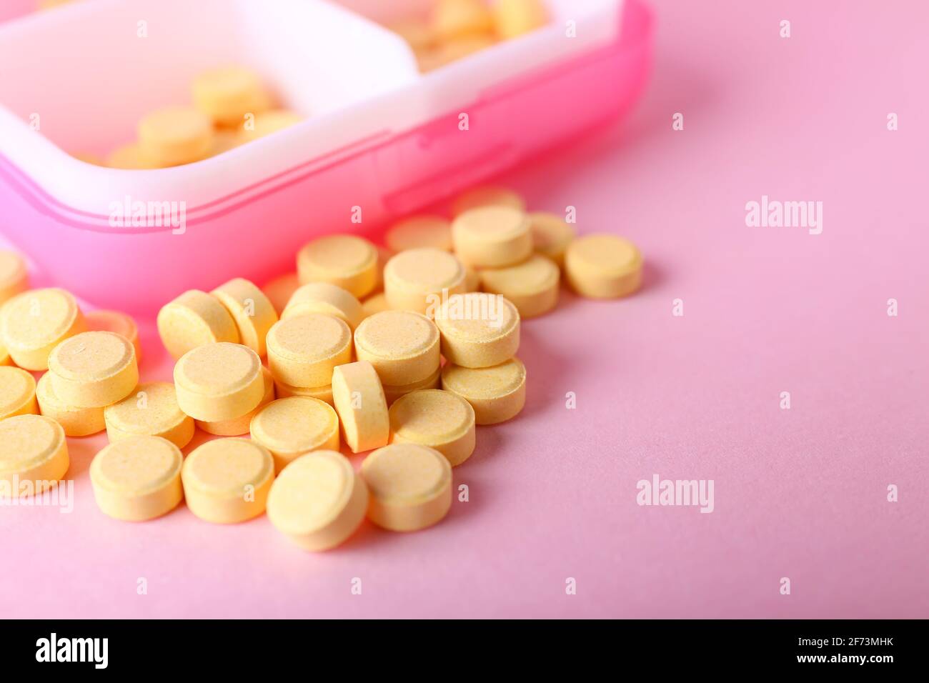 Container with folic acid pills on color background Stock Photo - Alamy