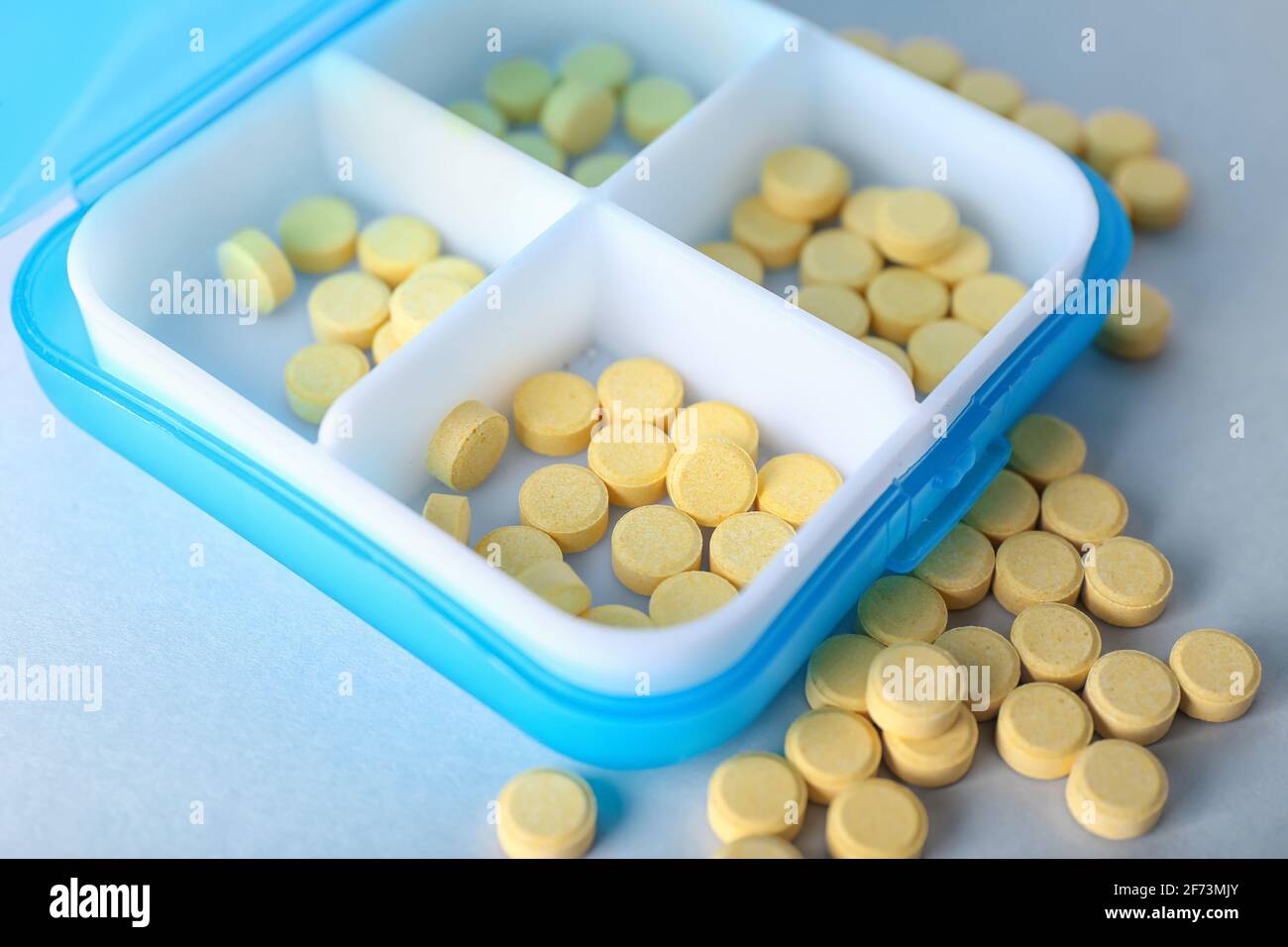 Container with folic acid pills on light background Stock Photo - Alamy