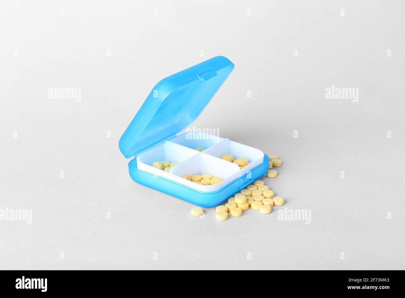 Container with folic acid pills on light background Stock Photo - Alamy