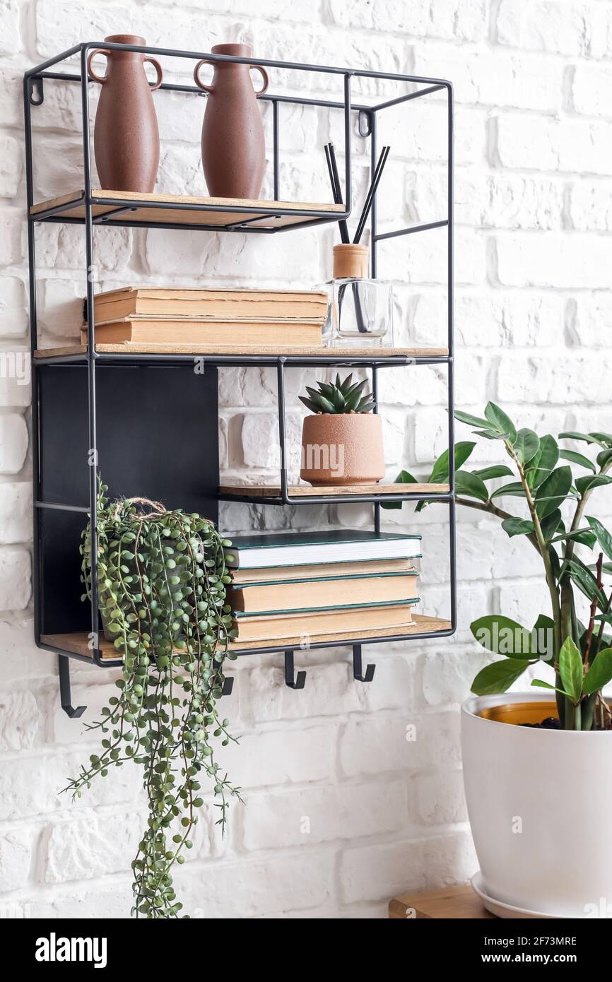Hanging shelves on brick wall hi-res stock photography and images - Alamy