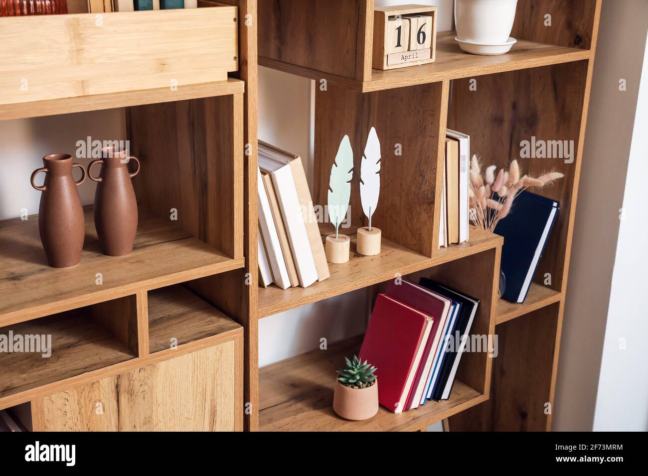 Modern shelf units with books and decor, closeup Stock Photo - Alamy