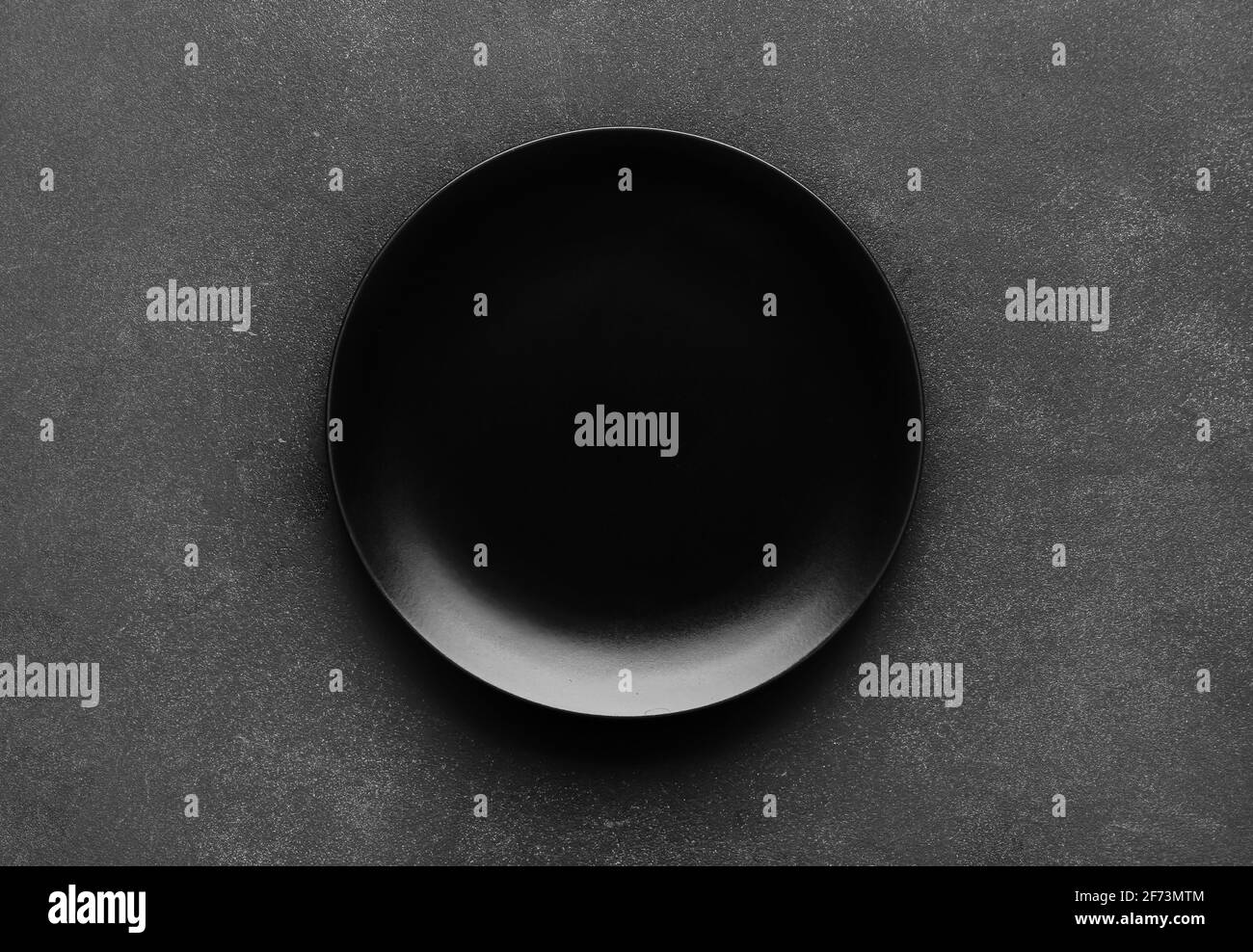 Stylish plate on dark background Stock Photo - Alamy