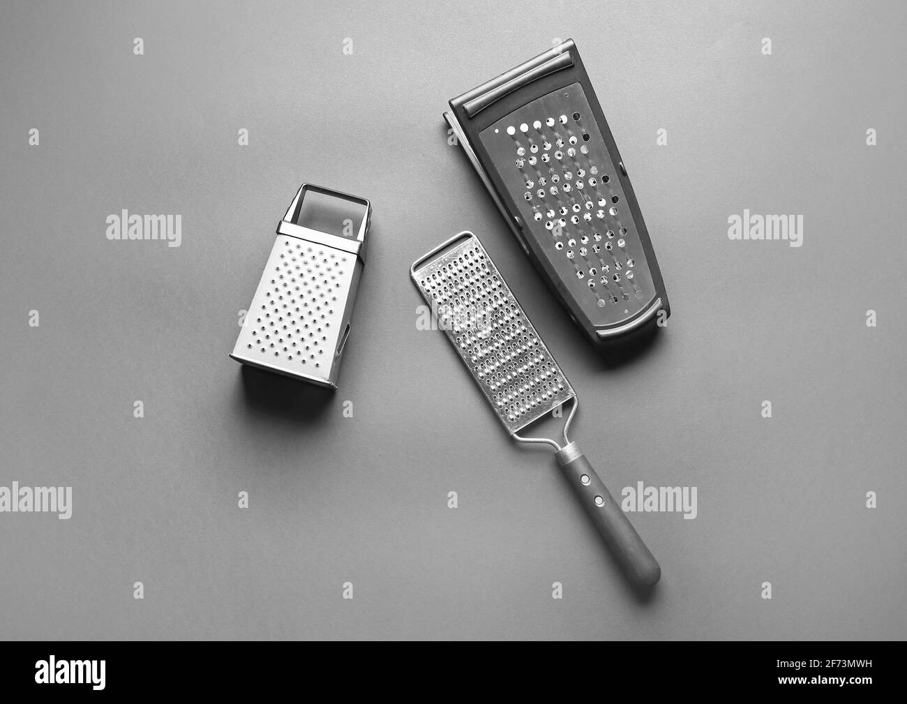 Different graters on dark background Stock Photo - Alamy